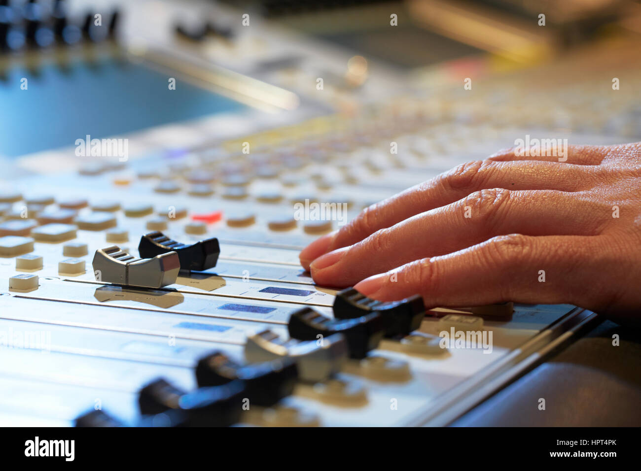 Professional audio mixing console with faders and adjusting knobs ...