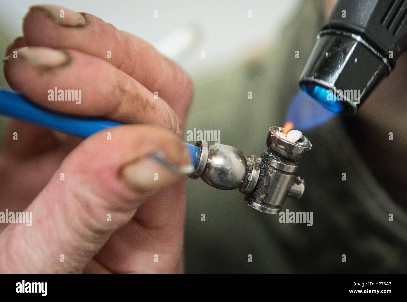 A drug addict lights crack using a gas burner in Frankfurt/Main ...