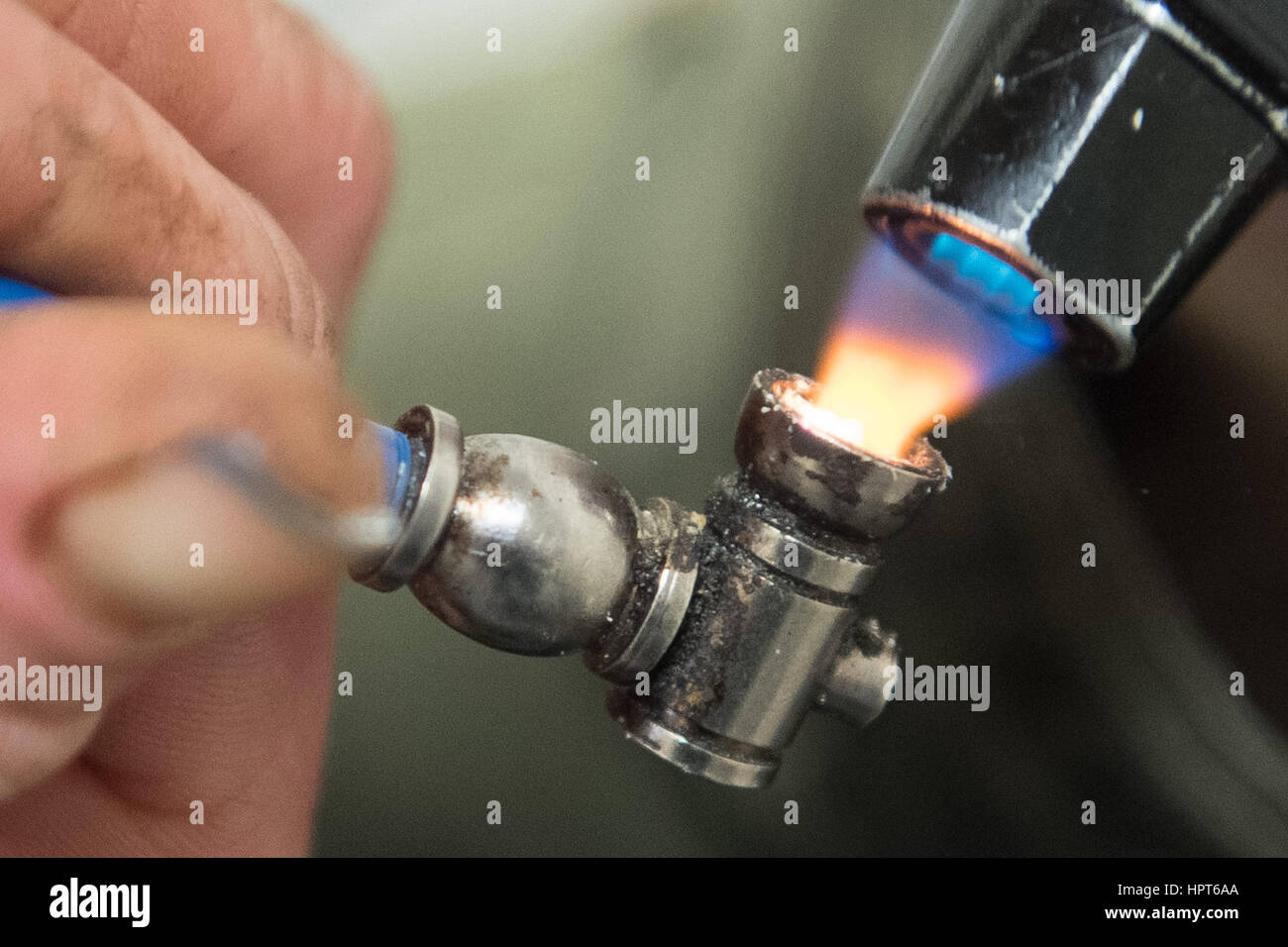 A drug addict lights crack using a gas burner in Frankfurt/Main ...