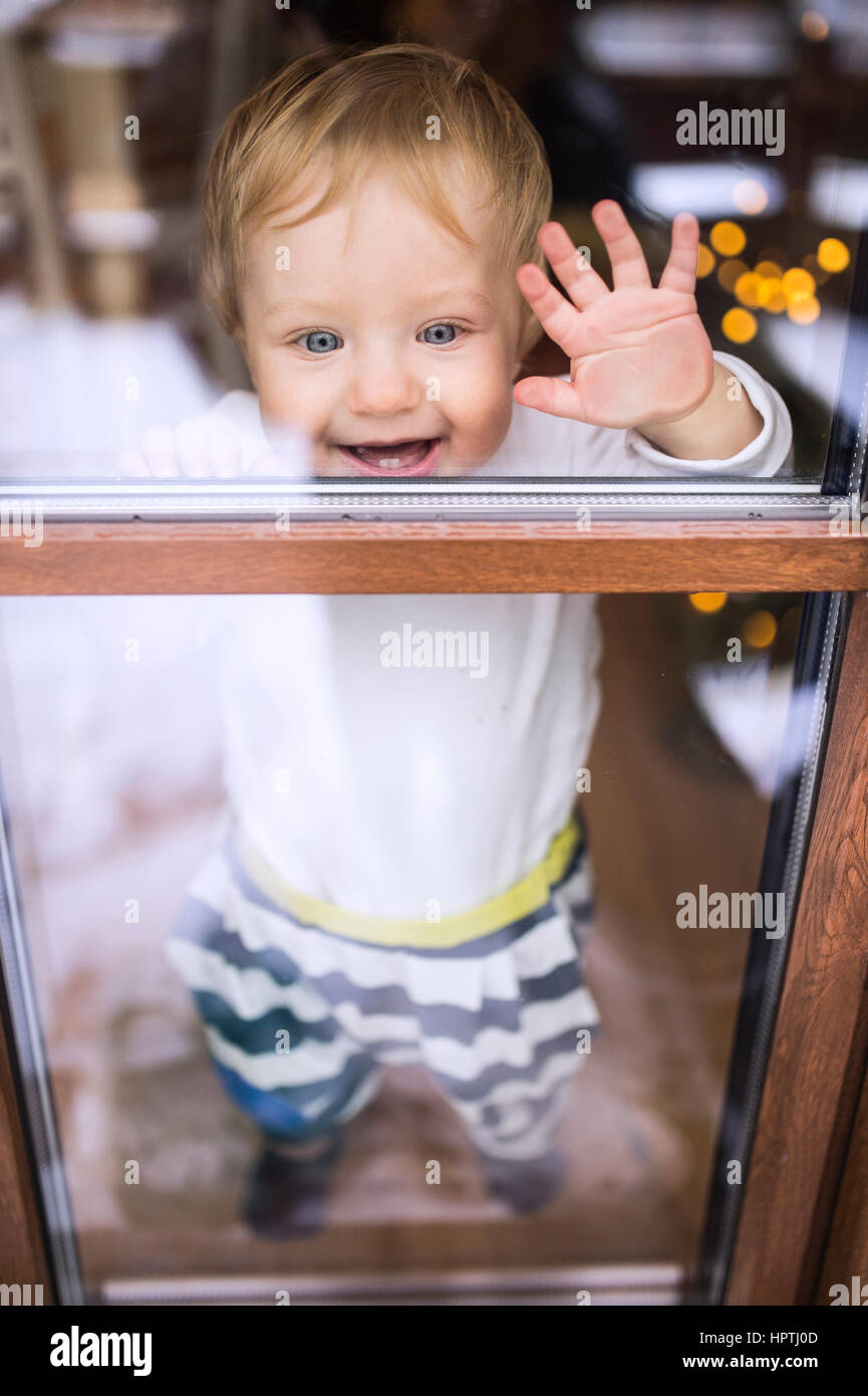 Laughing baby boy looking out of window Stock Photo - Alamy