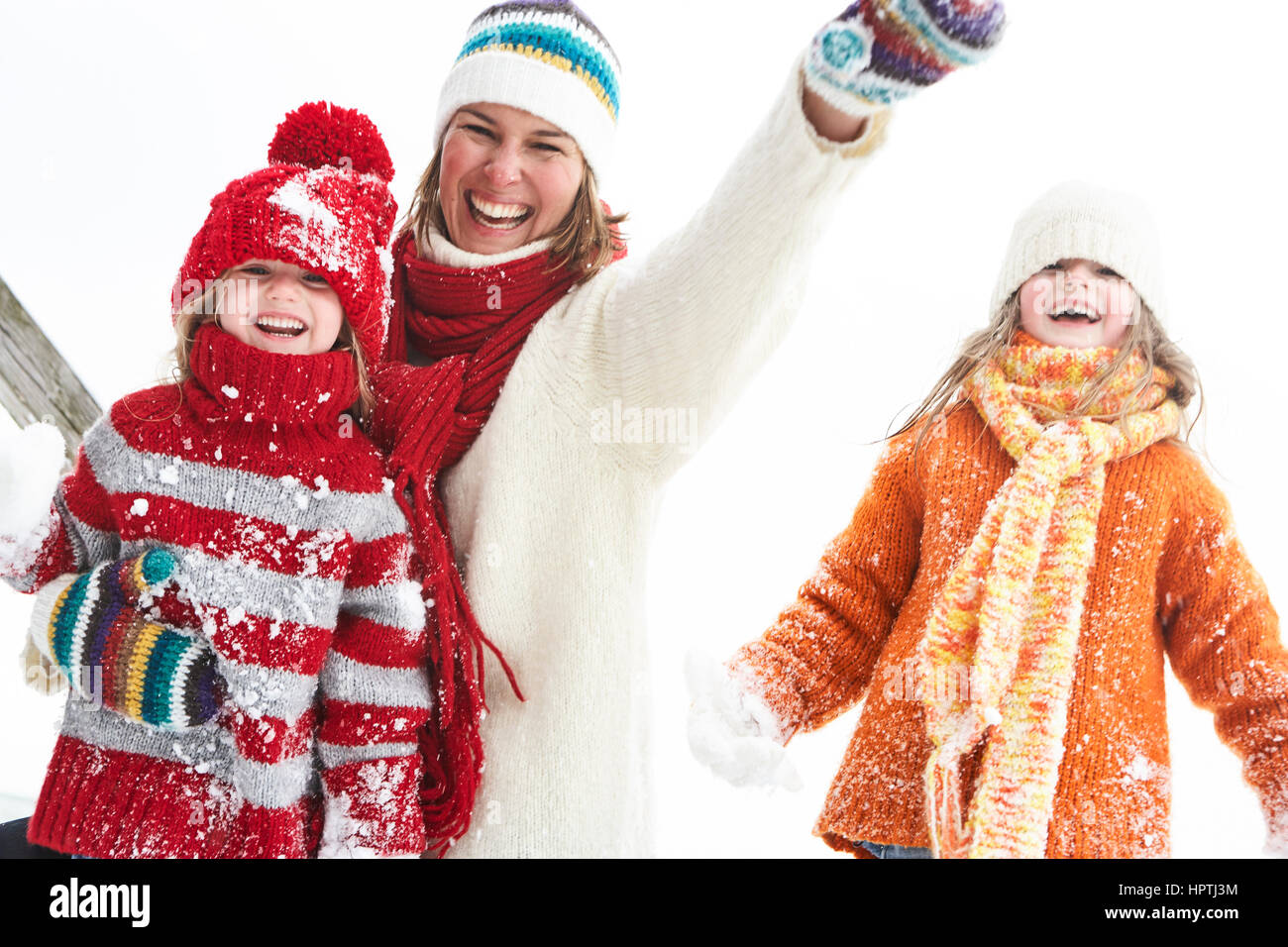 Mother and daughters having fun in winter Stock Photo - Alamy
