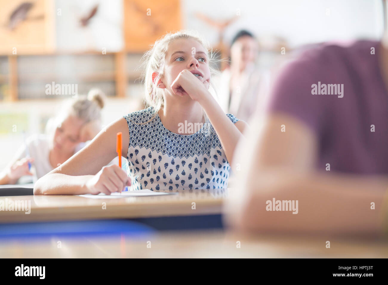 Female student in thought in class Stock Photo - Alamy