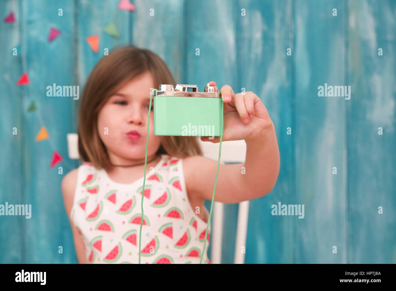 Little girl playing with vintage toy camera Stock Photo - Alamy