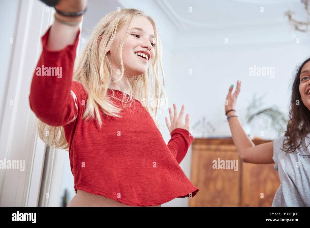 Two happy girls dancing at home Stock Photo - Alamy