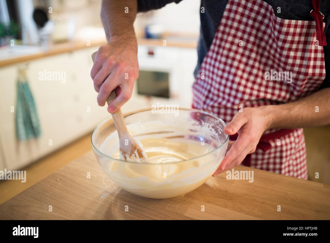 Man standing in kitchen, preparing cake dough Stock Photo - Alamy