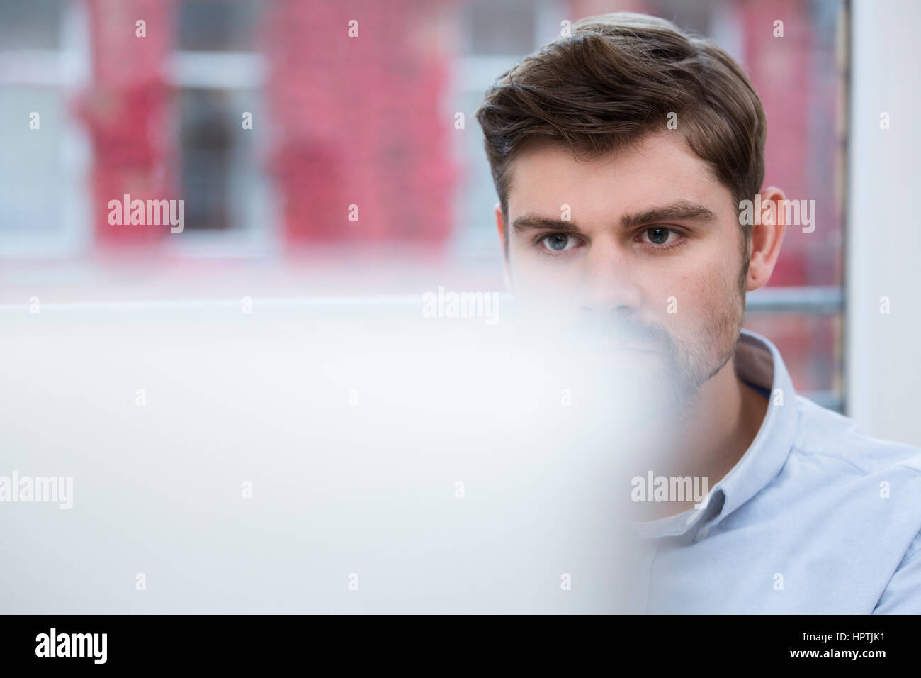 Man looking at computer screen Stock Photo - Alamy