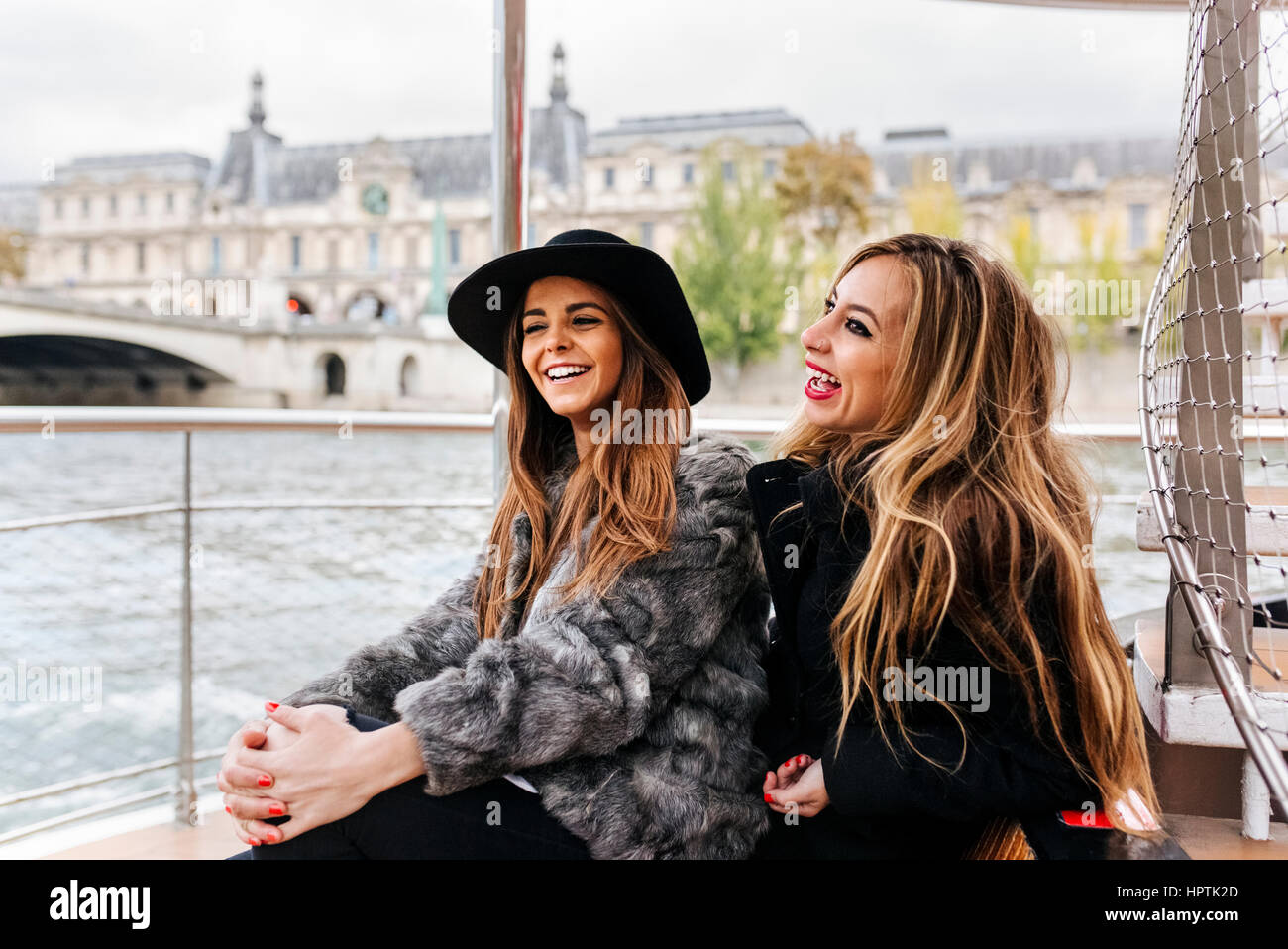 Paris, France, two laughing tourists taking a cruise on Seine River ...