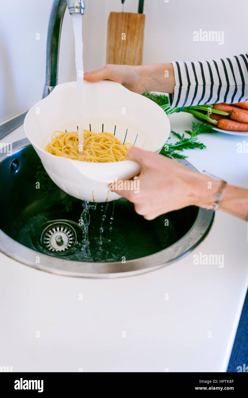 Young woman cooking pasta Stock Photo - Alamy