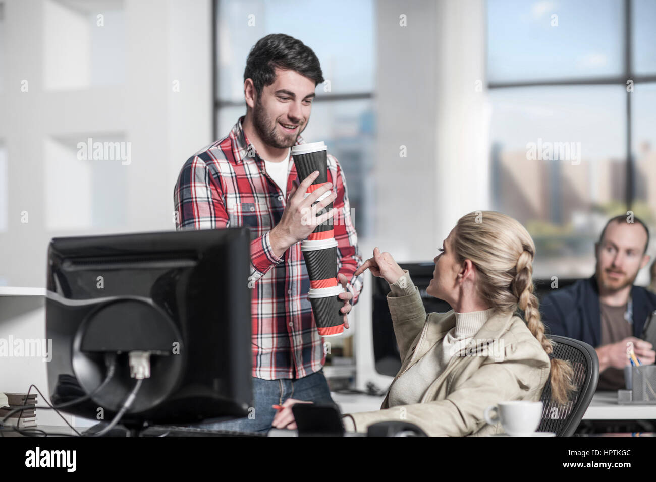 Man delivering coffee to office workers Stock Photo - Alamy