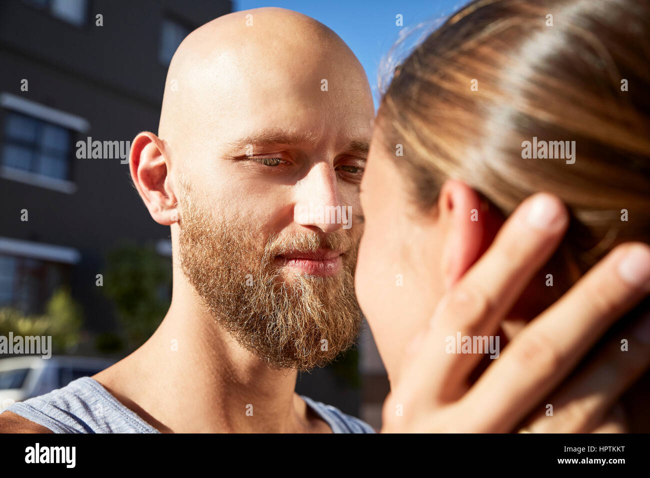 Portrait of bald young man face to face with his girlfriend Stock Photo ...