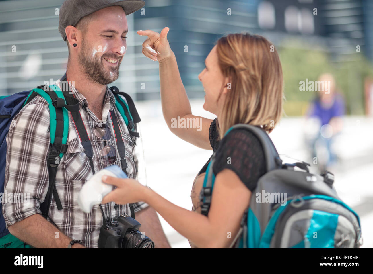 Young couple applying sunscreen hi-res stock photography and images - Alamy