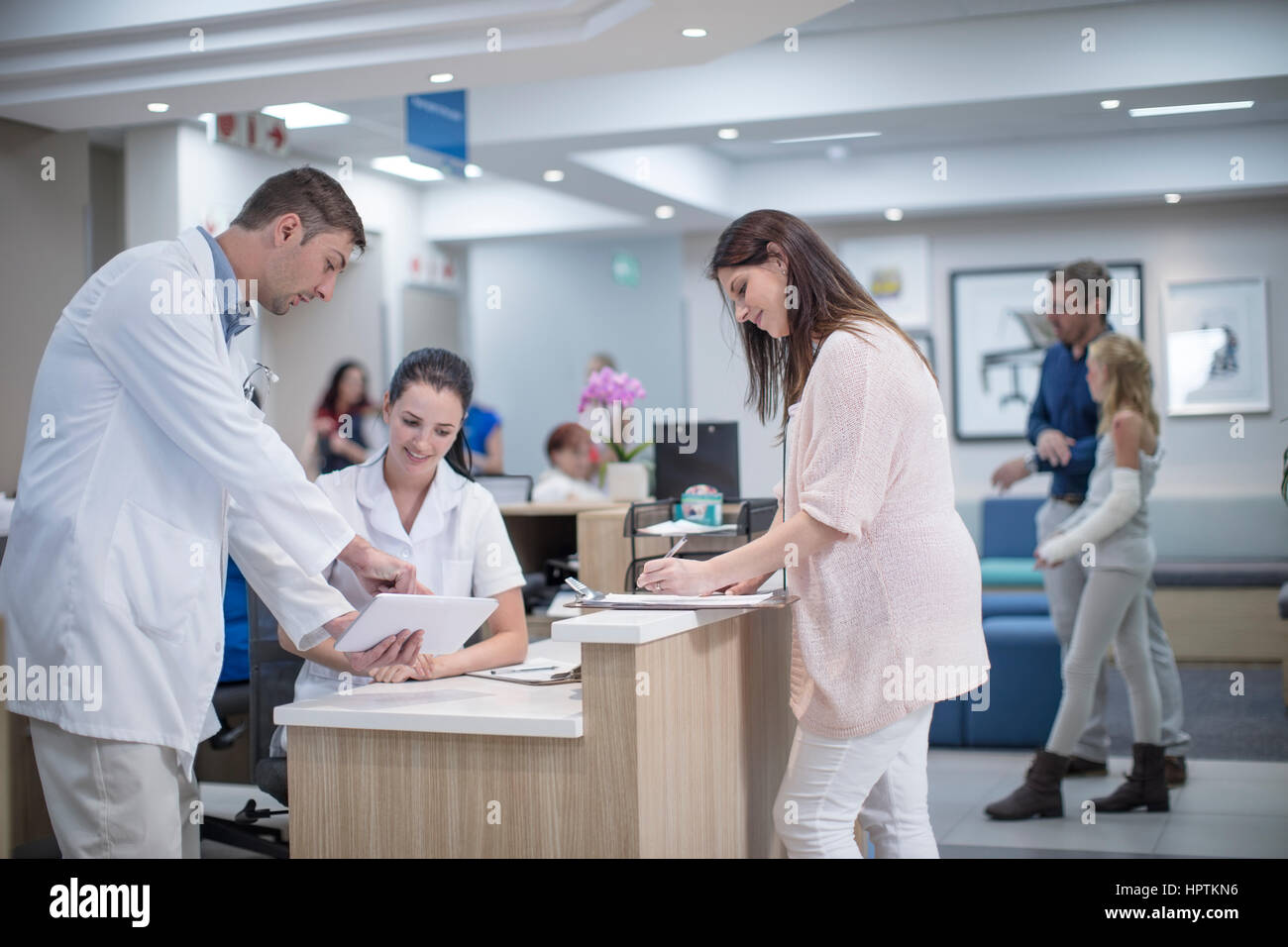 Medical staff standing in reception area Stock Photo - Alamy