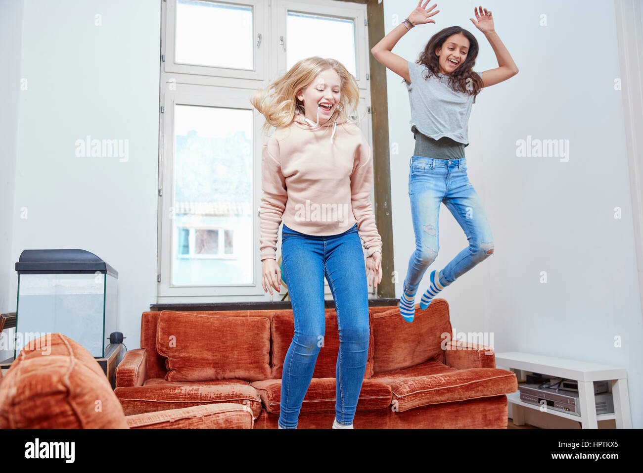 Two happy girls jump hi-res stock photography and images - Alamy