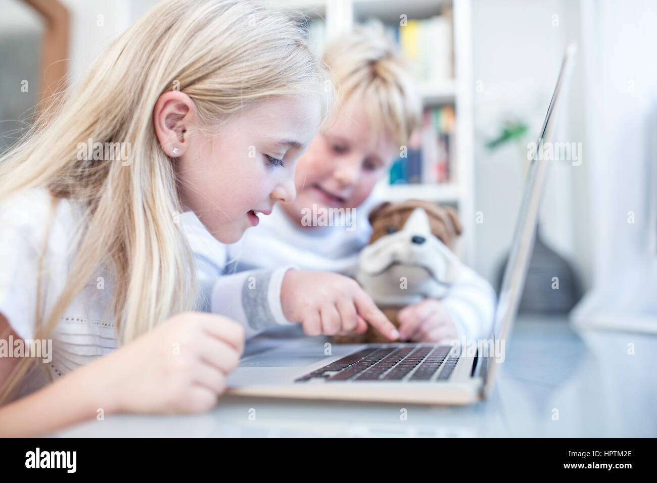 Brother and sister using laptop together Stock Photo - Alamy