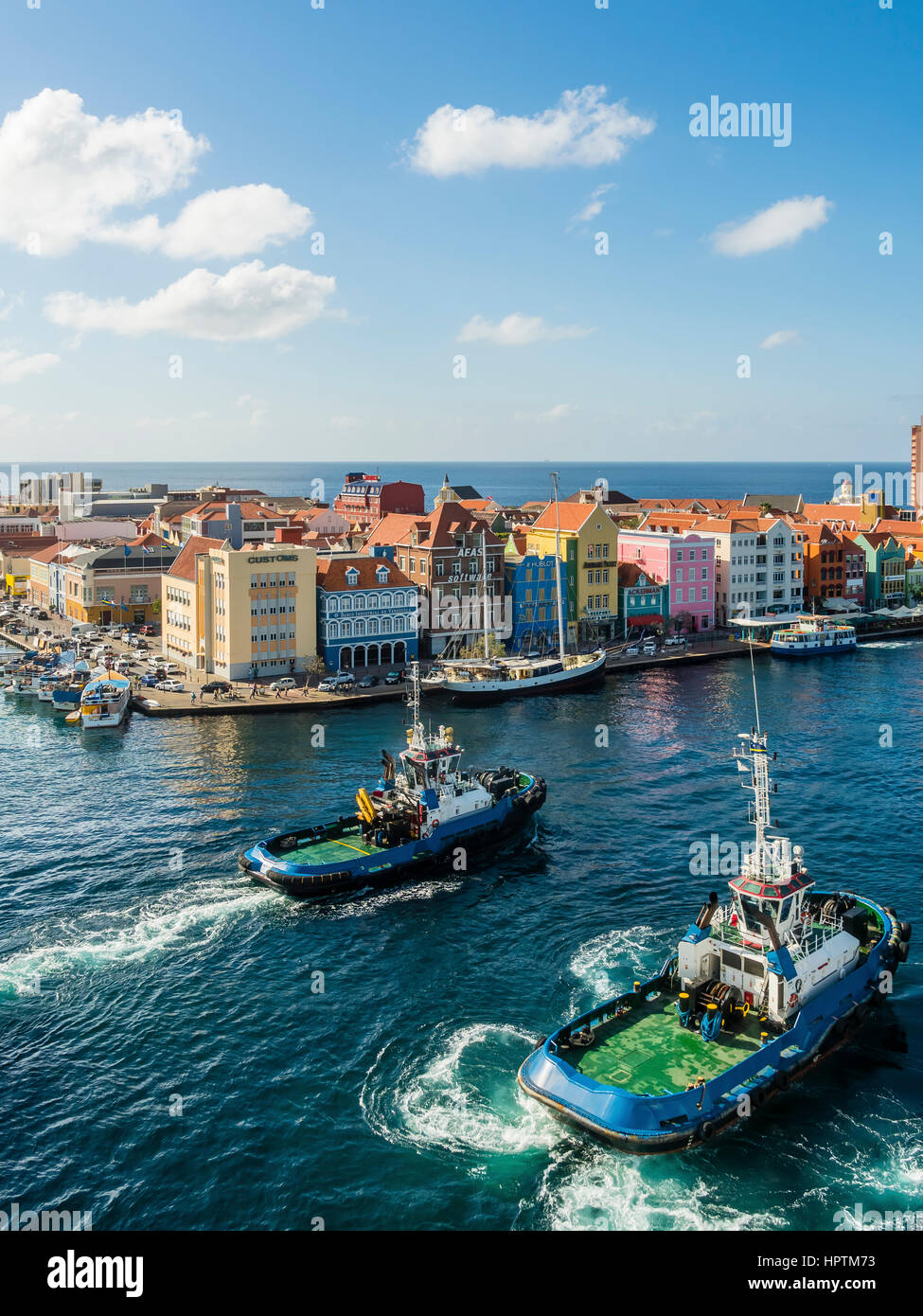 Curacao, Willemstad, Punda, tugboats and colorful houses at waterfront ...