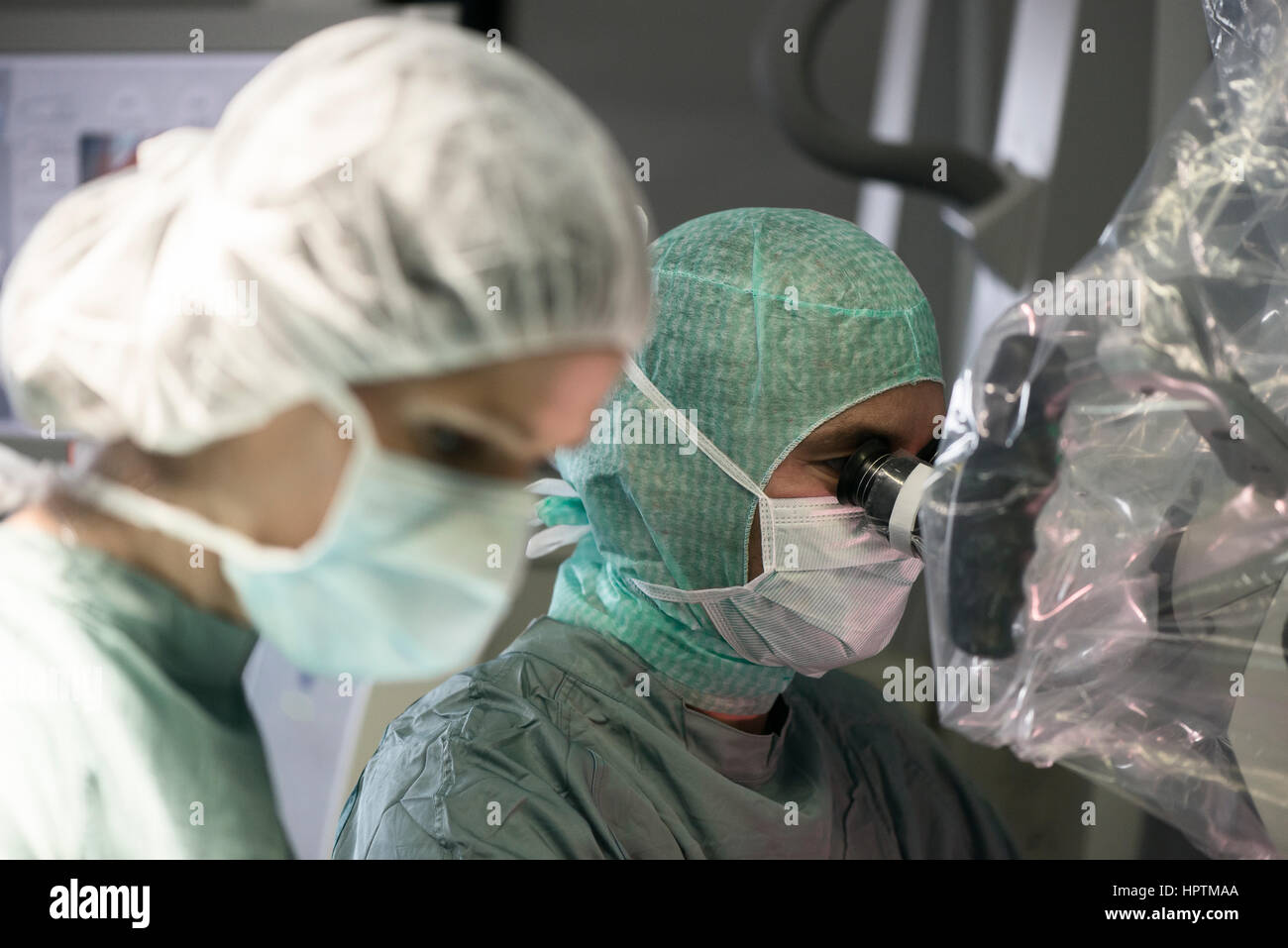 Neurosurgeon and operating room nurse during an operation Stock Photo ...