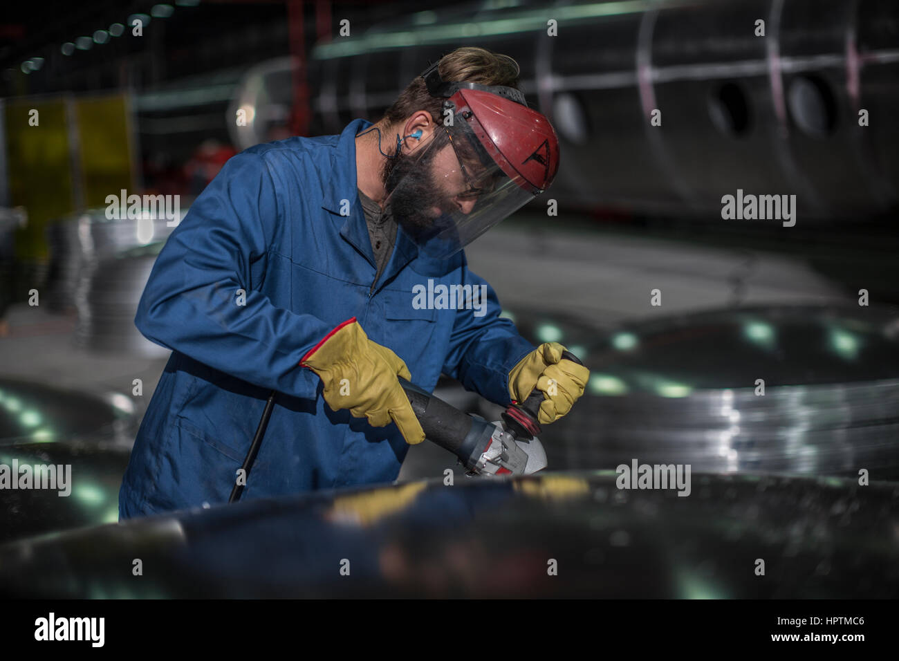 Factory worker operating steel cutter Stock Photo - Alamy