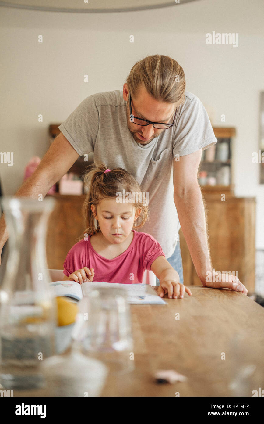 Father checking homework of his daughter Stock Photo - Alamy