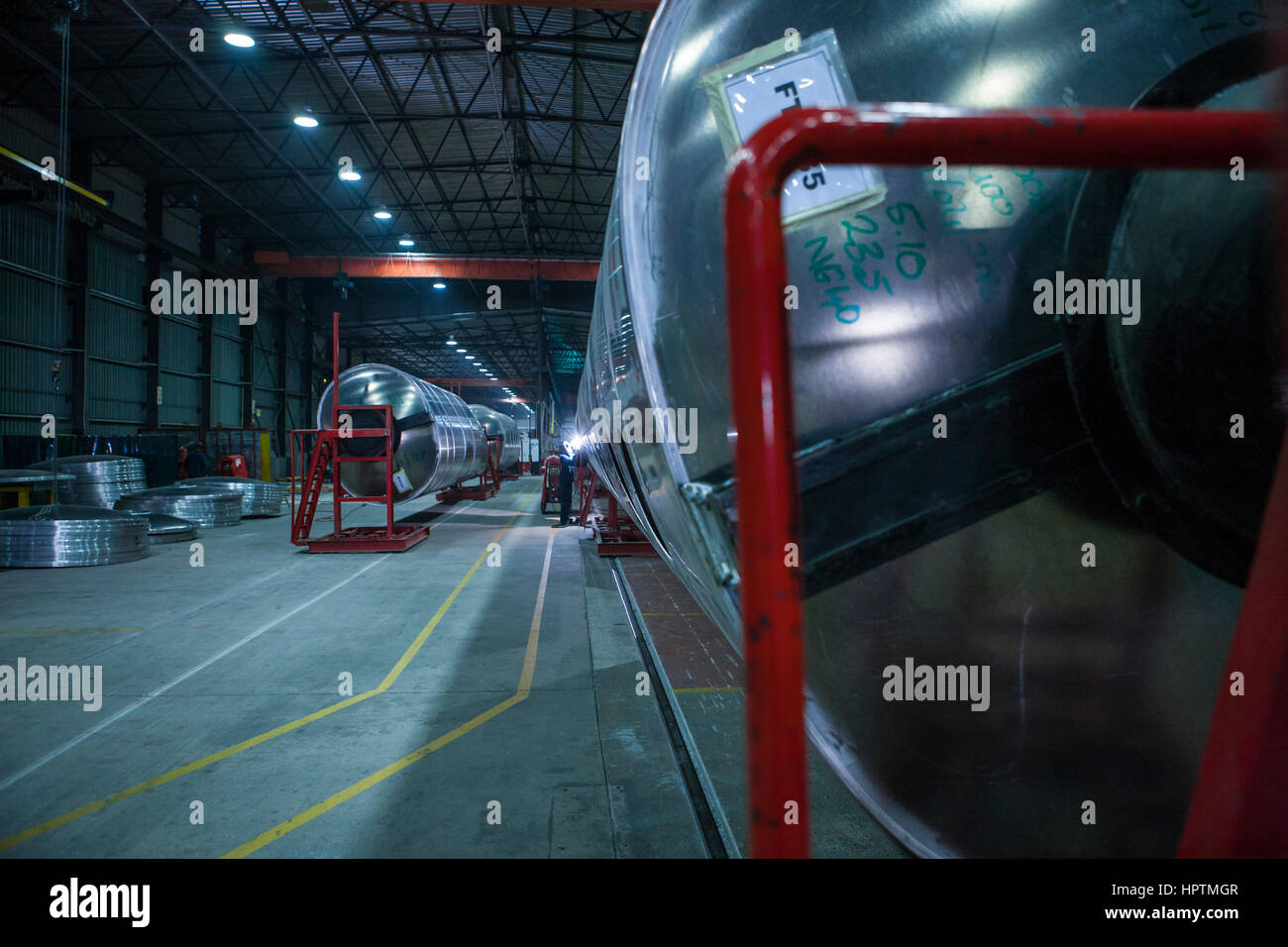 Man welding large steel tank in factory Stock Photo - Alamy