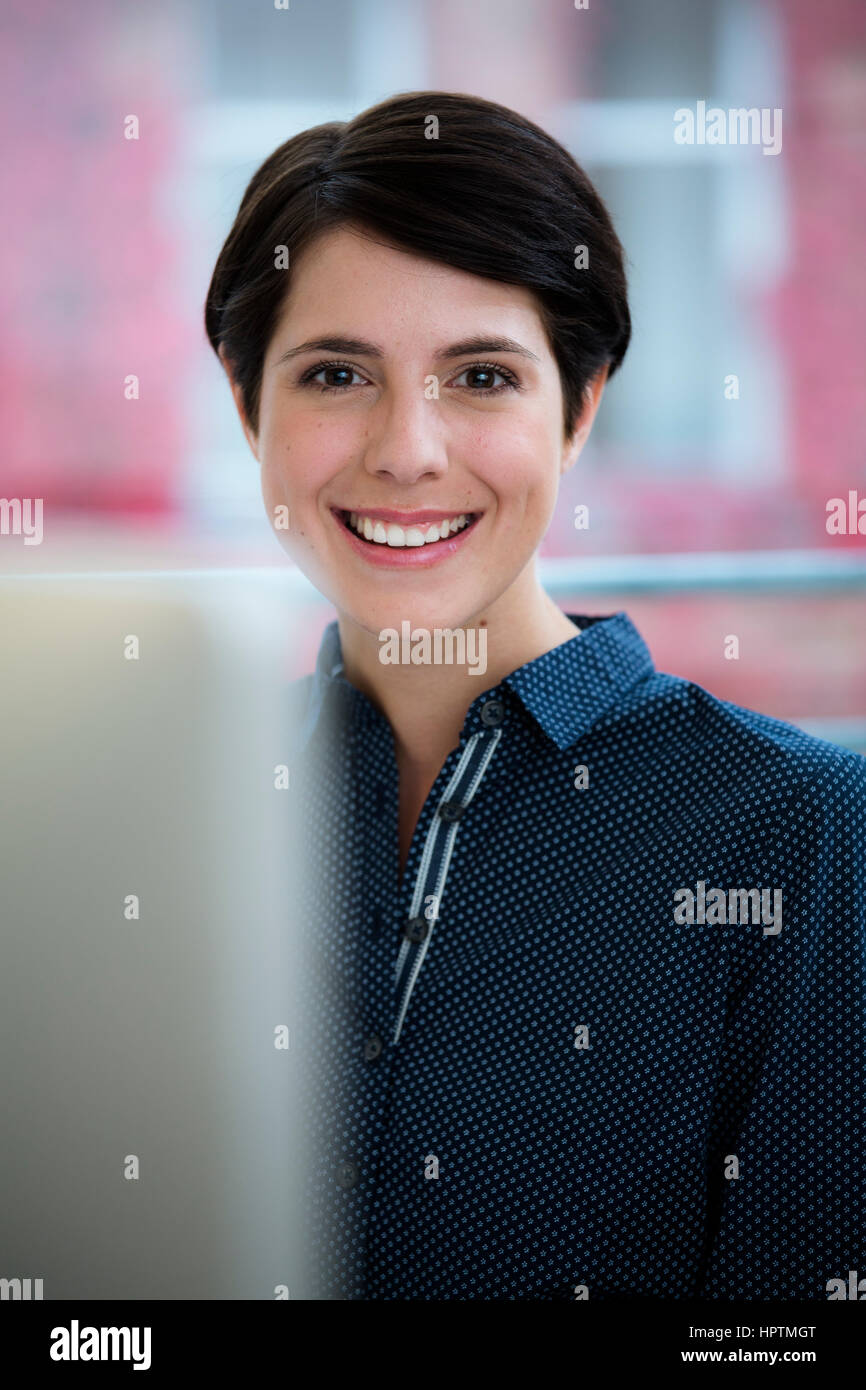 Portrait of smiling woman in office Stock Photo - Alamy