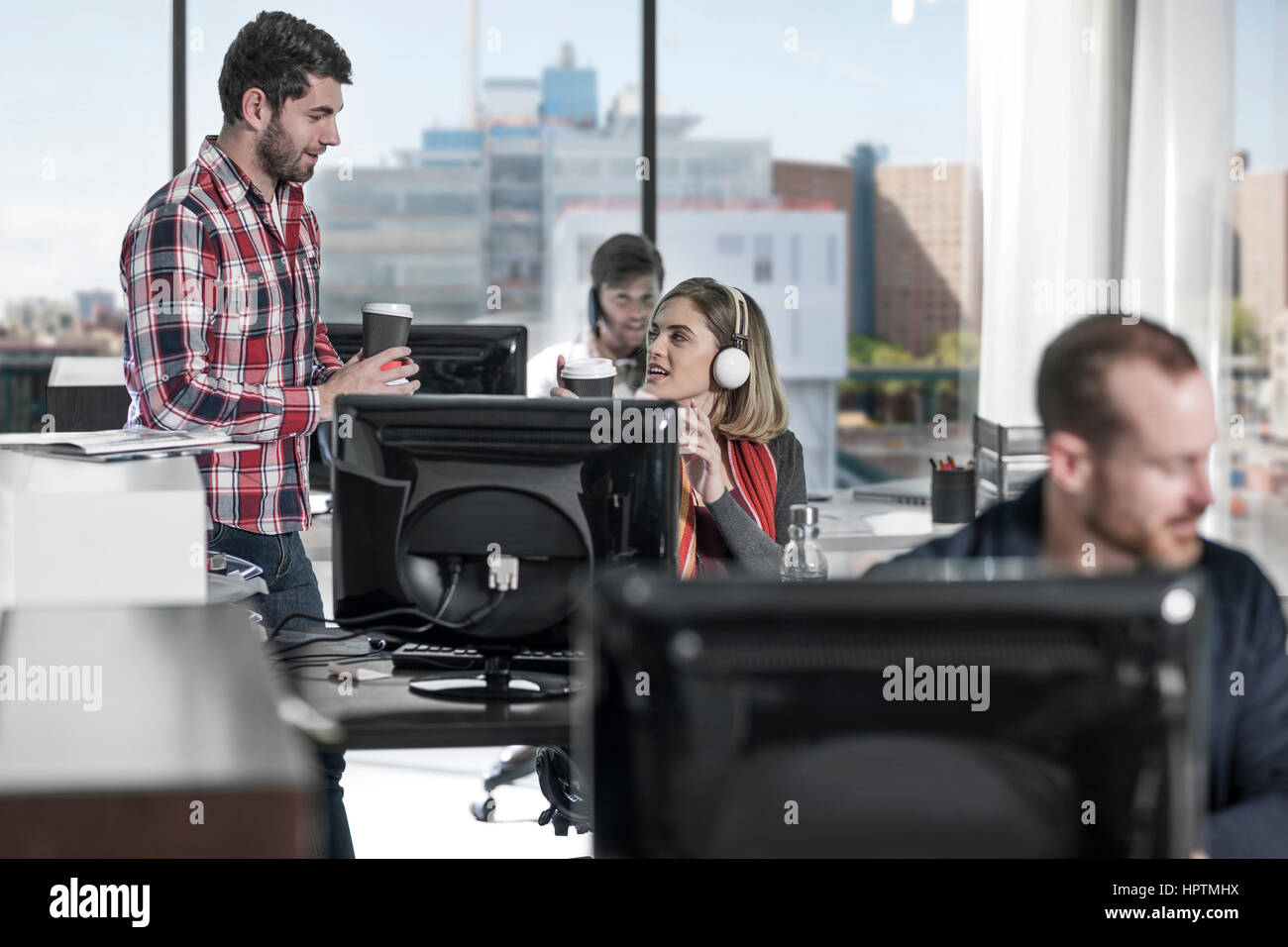 Man delivering coffee to office workers Stock Photo - Alamy