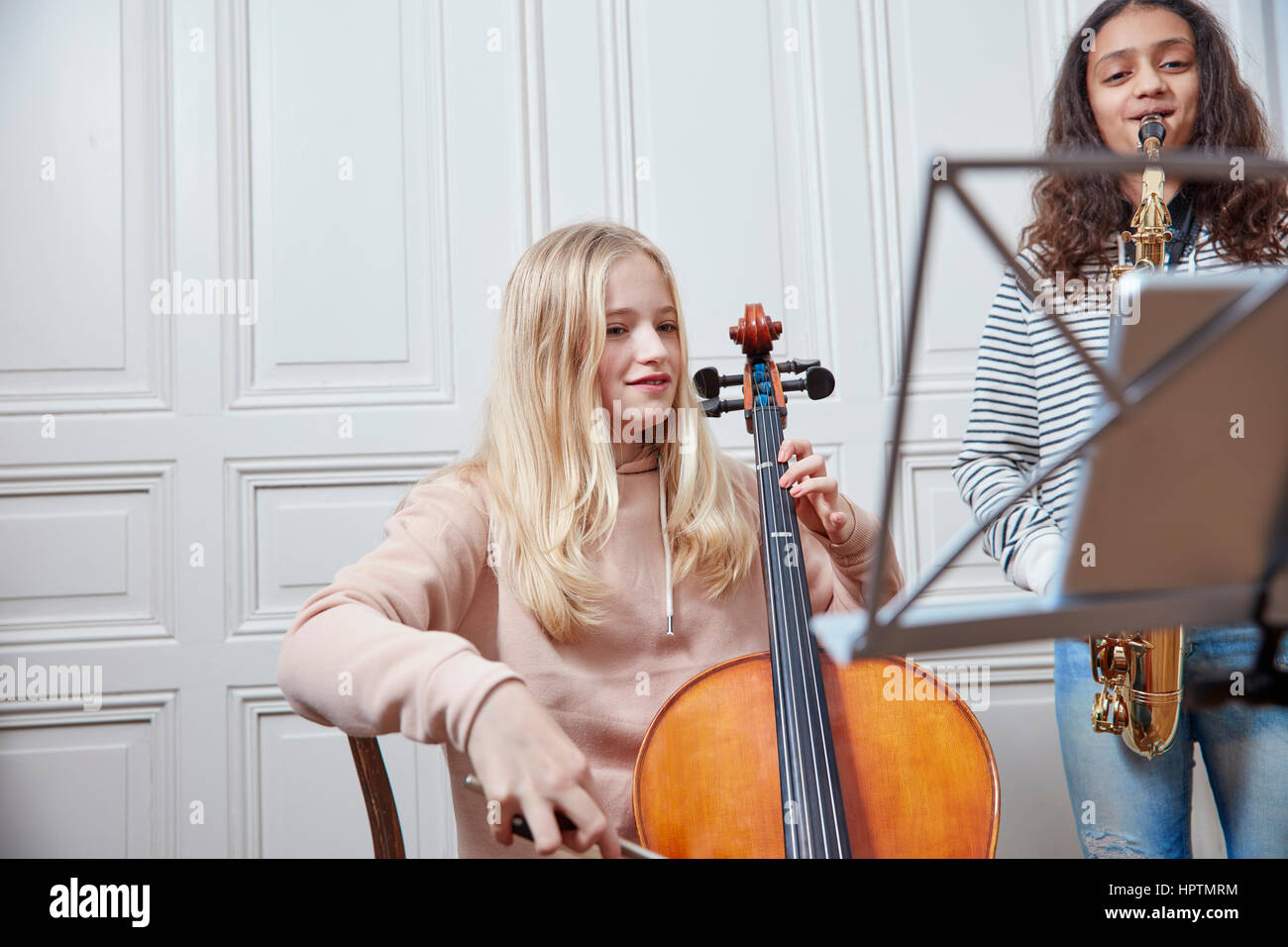 Girl playing saxophone hi-res stock photography and images - Alamy
