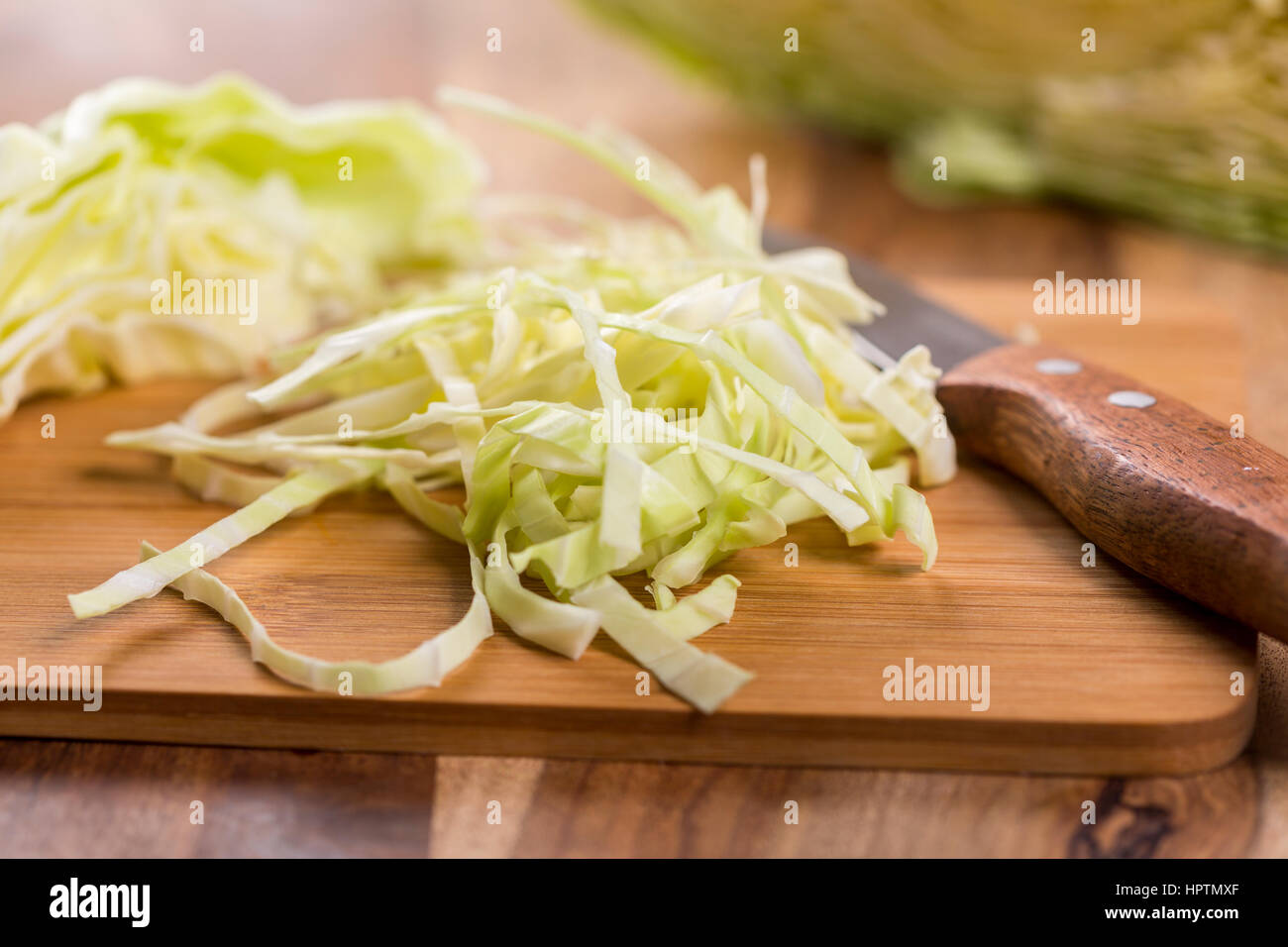 Chopped cabbage on wooden board Stock Photo - Alamy