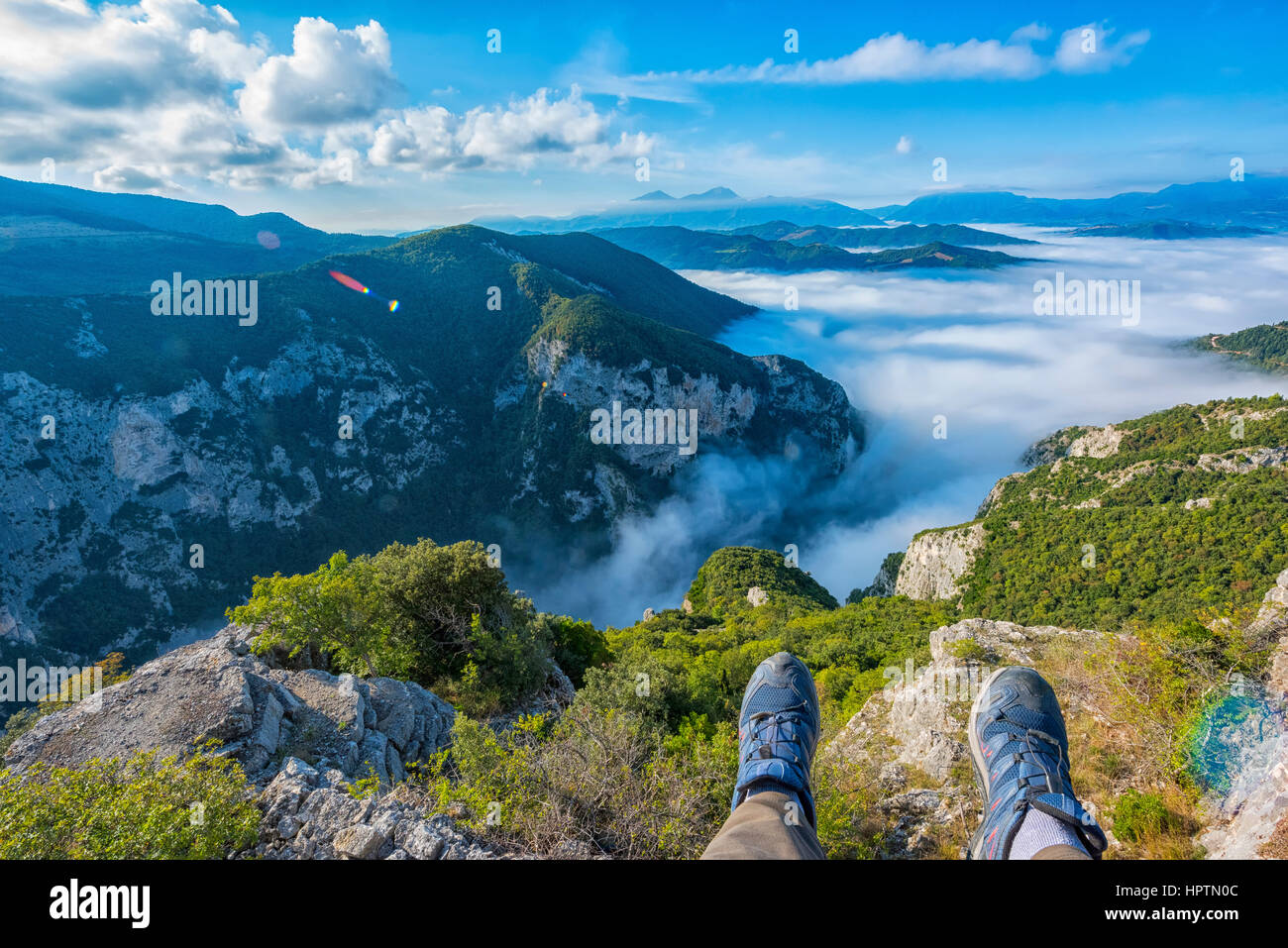 Italy, Marche, Apennines Mountains, Furlo Pass, feet of resting hiker ...