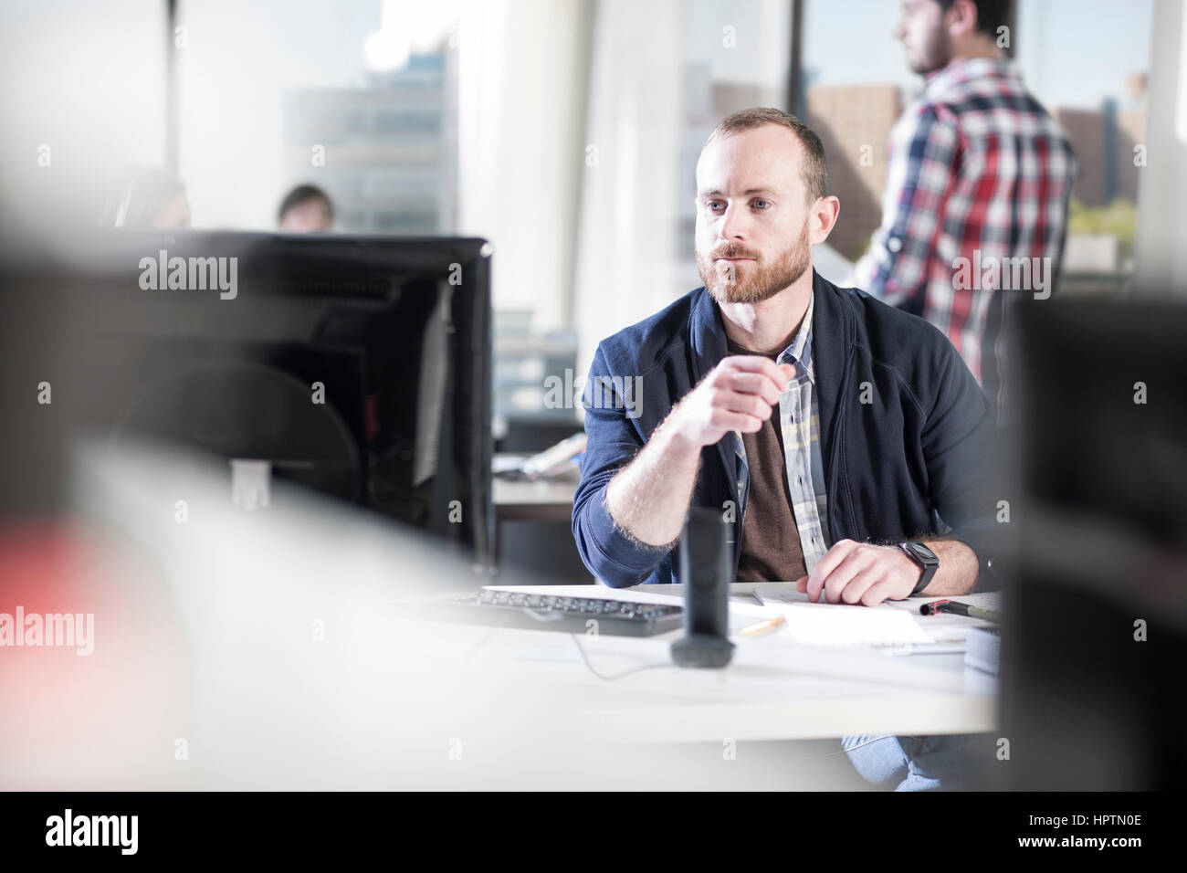 Man working at desk in office Stock Photo - Alamy