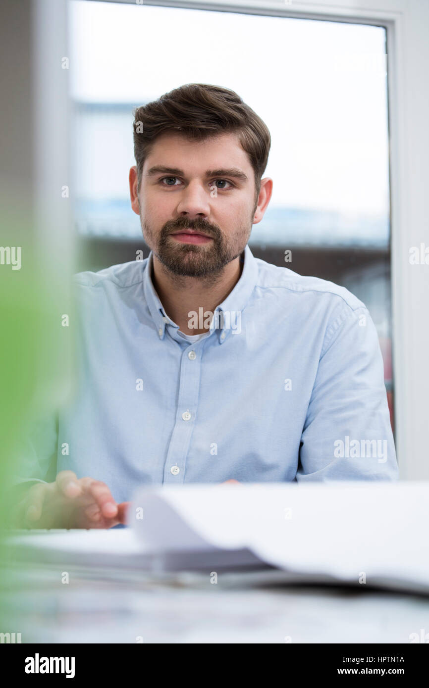 Man working at desk in office Stock Photo - Alamy