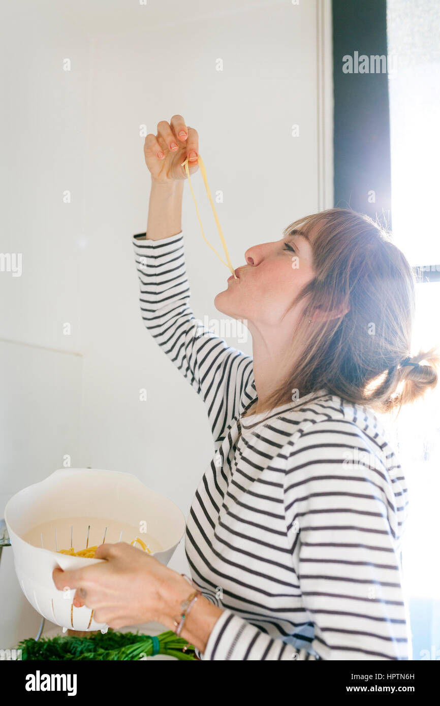 Young woman cooking pasta Stock Photo - Alamy