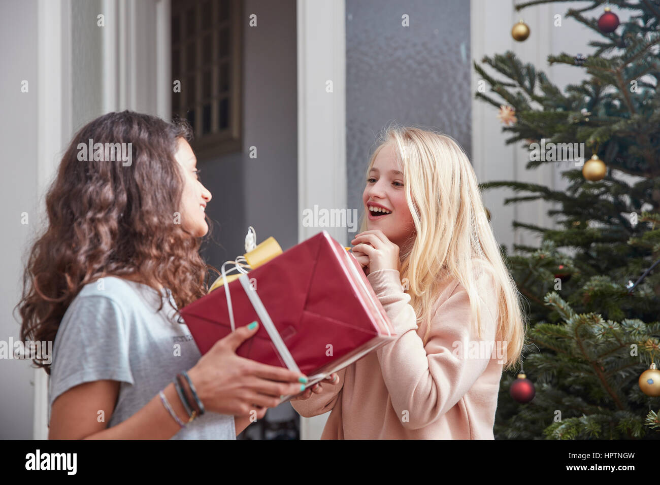 Child handing present to child hi-res stock photography and images - Alamy