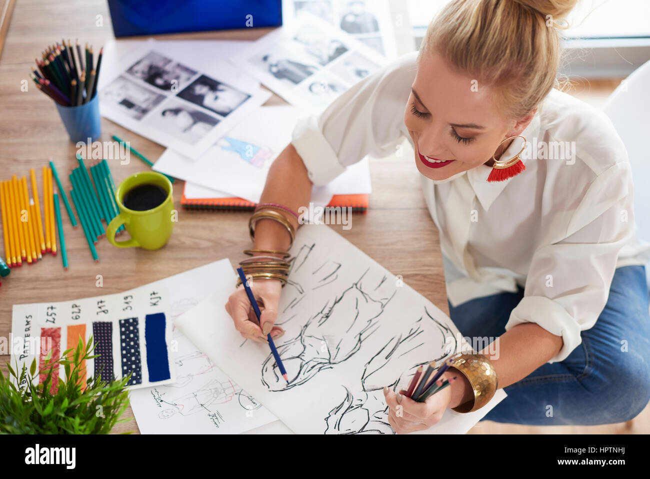 Artist woman putting much effort on her work Stock Photo - Alamy