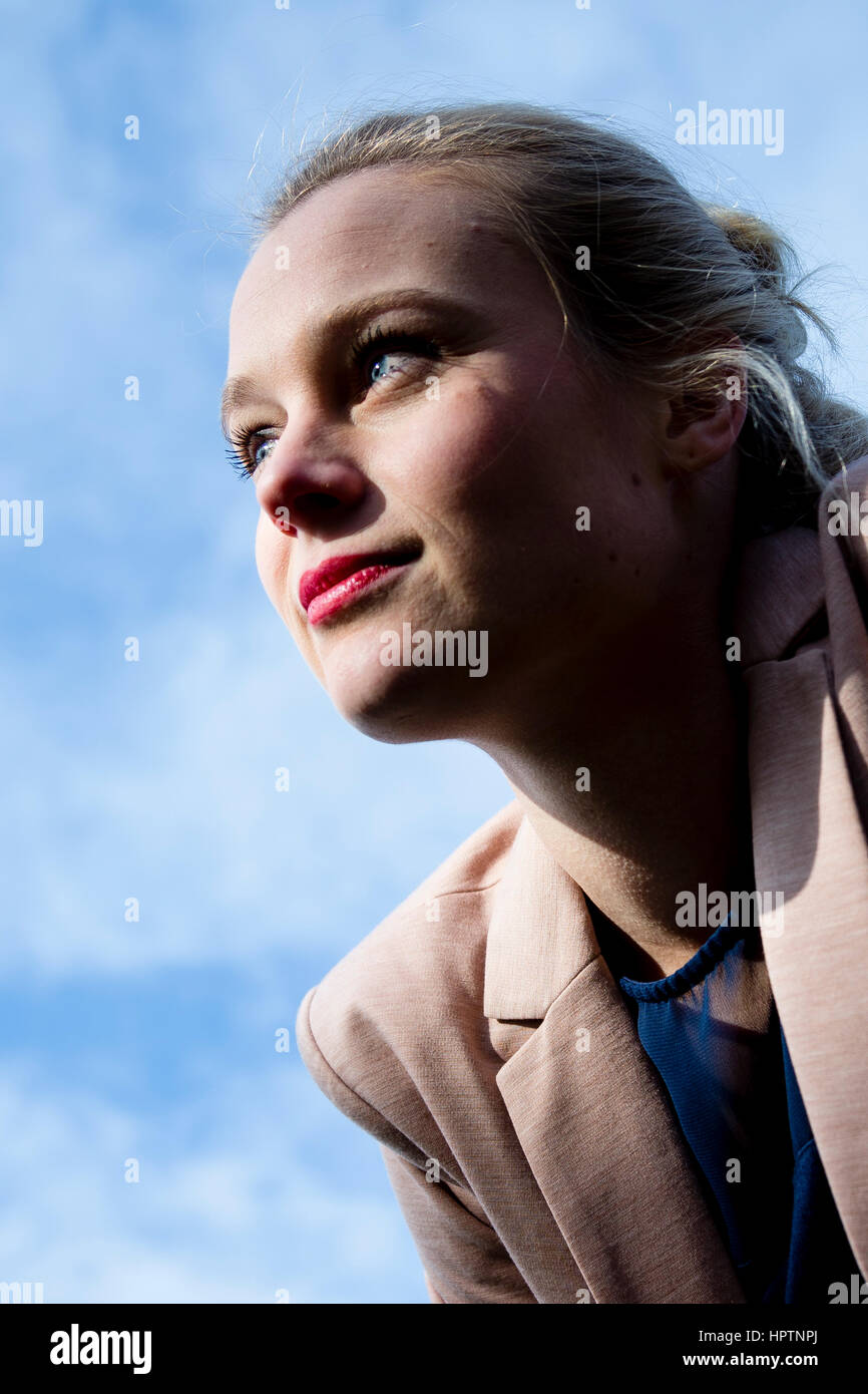 Young blonde woman outdoors looking away Stock Photo - Alamy