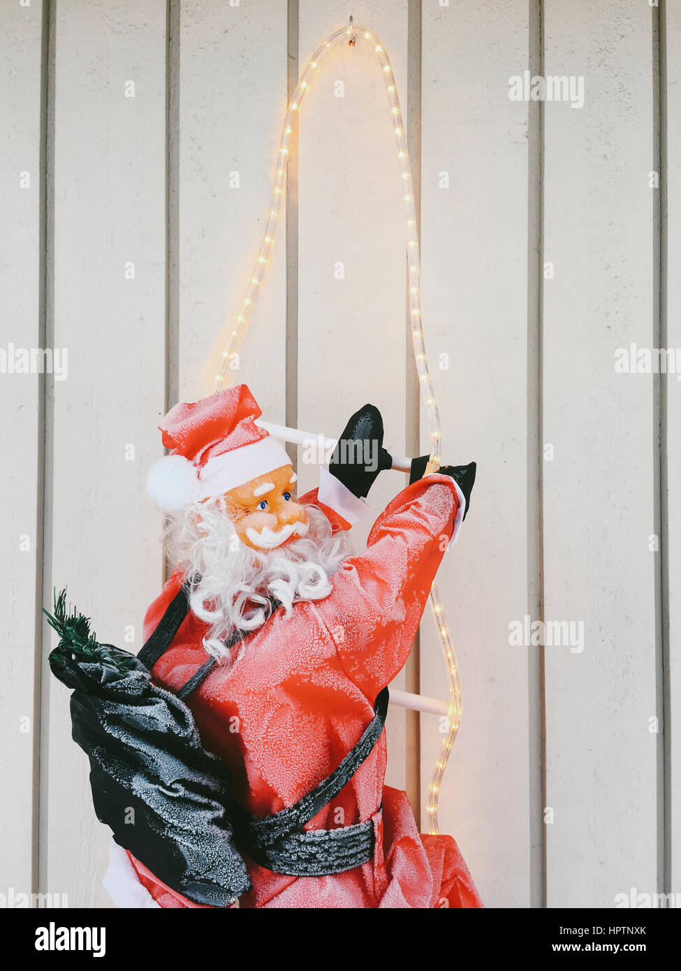 Father christmas santa climbing up hi-res stock photography and images ...