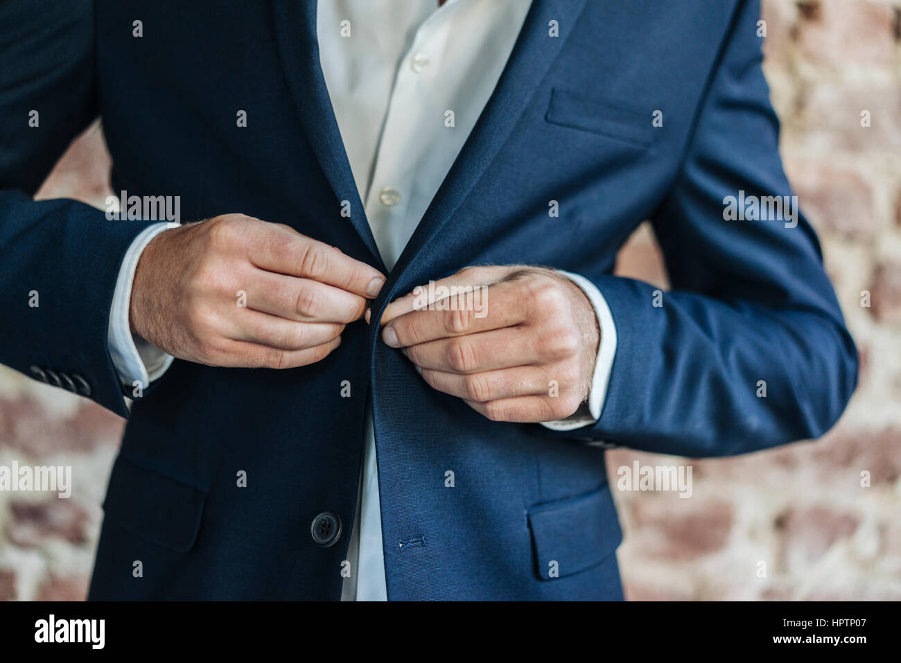 Businessman buttoning jacket hi-res stock photography and images - Alamy