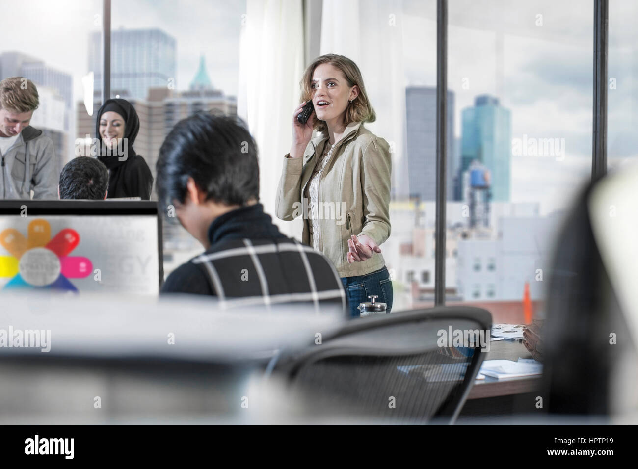 Woman on the phone in busy office Stock Photo - Alamy