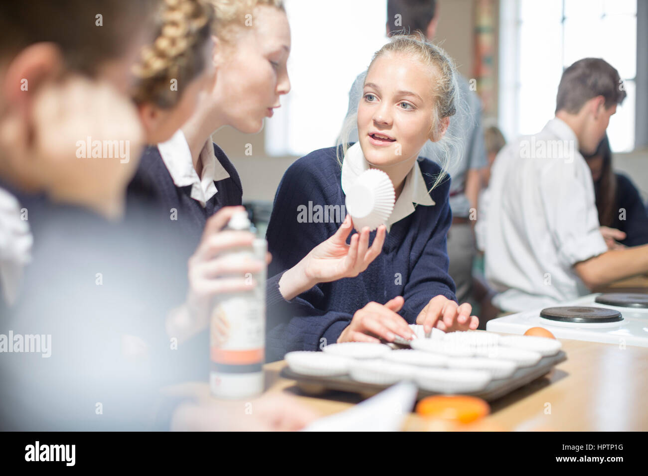 Teenage girls in high school cooking class discussing Stock Photo - Alamy