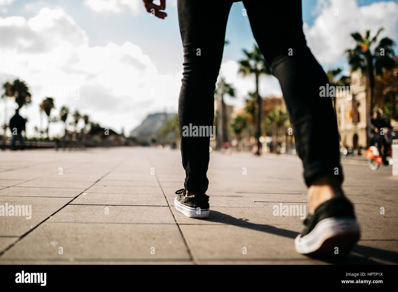 Legs of a man walking on pavement Stock Photo - Alamy