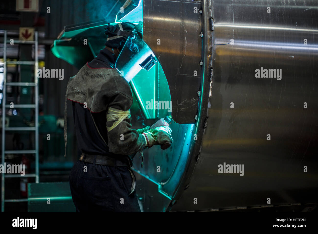 Man welding steel tank in factory Stock Photo - Alamy