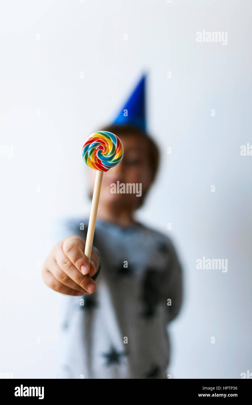 Hand of little boy holding lollipop, close-up Stock Photo - Alamy