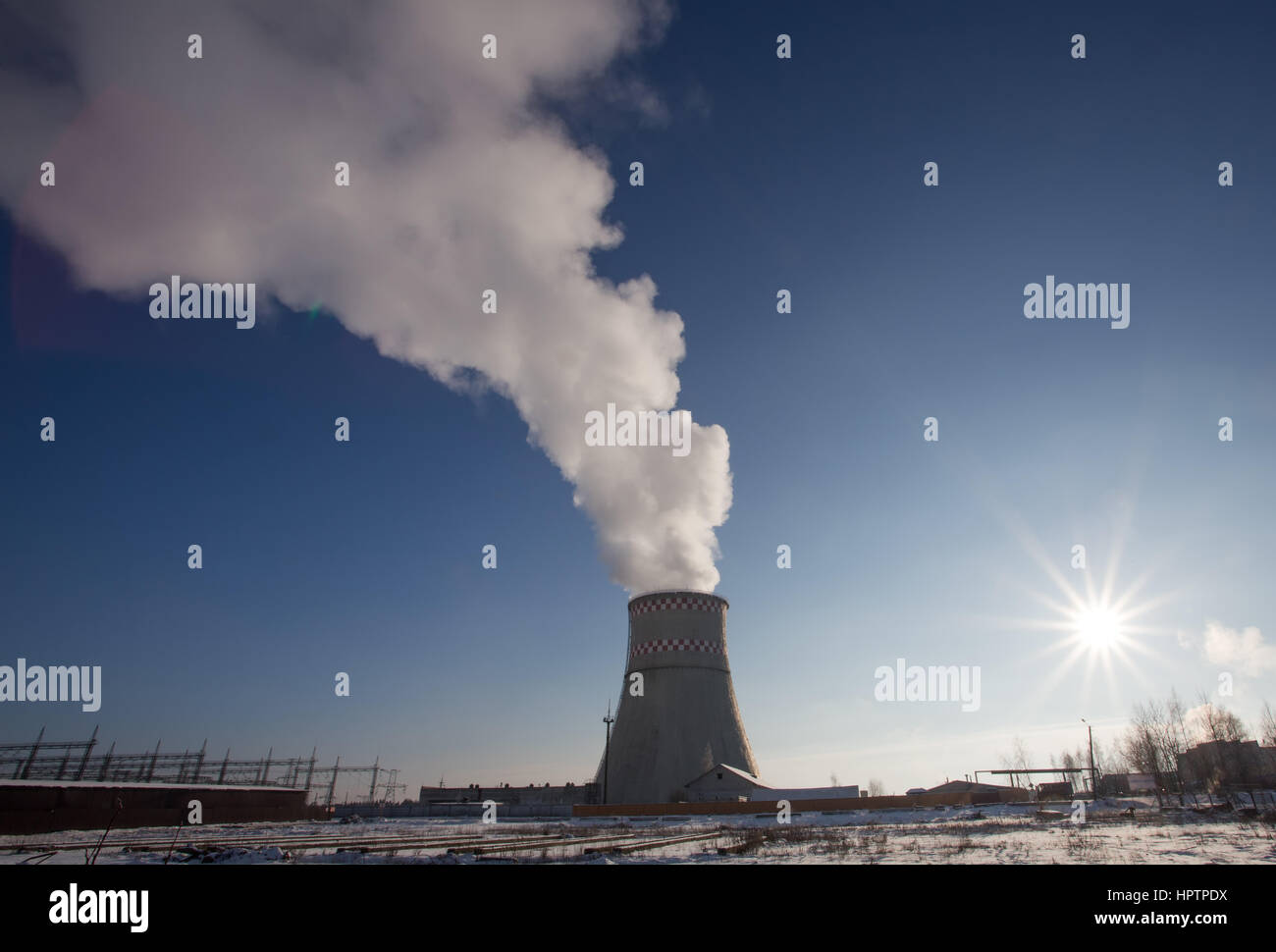 Power plant cooling system in front of the sun Stock Photo - Alamy