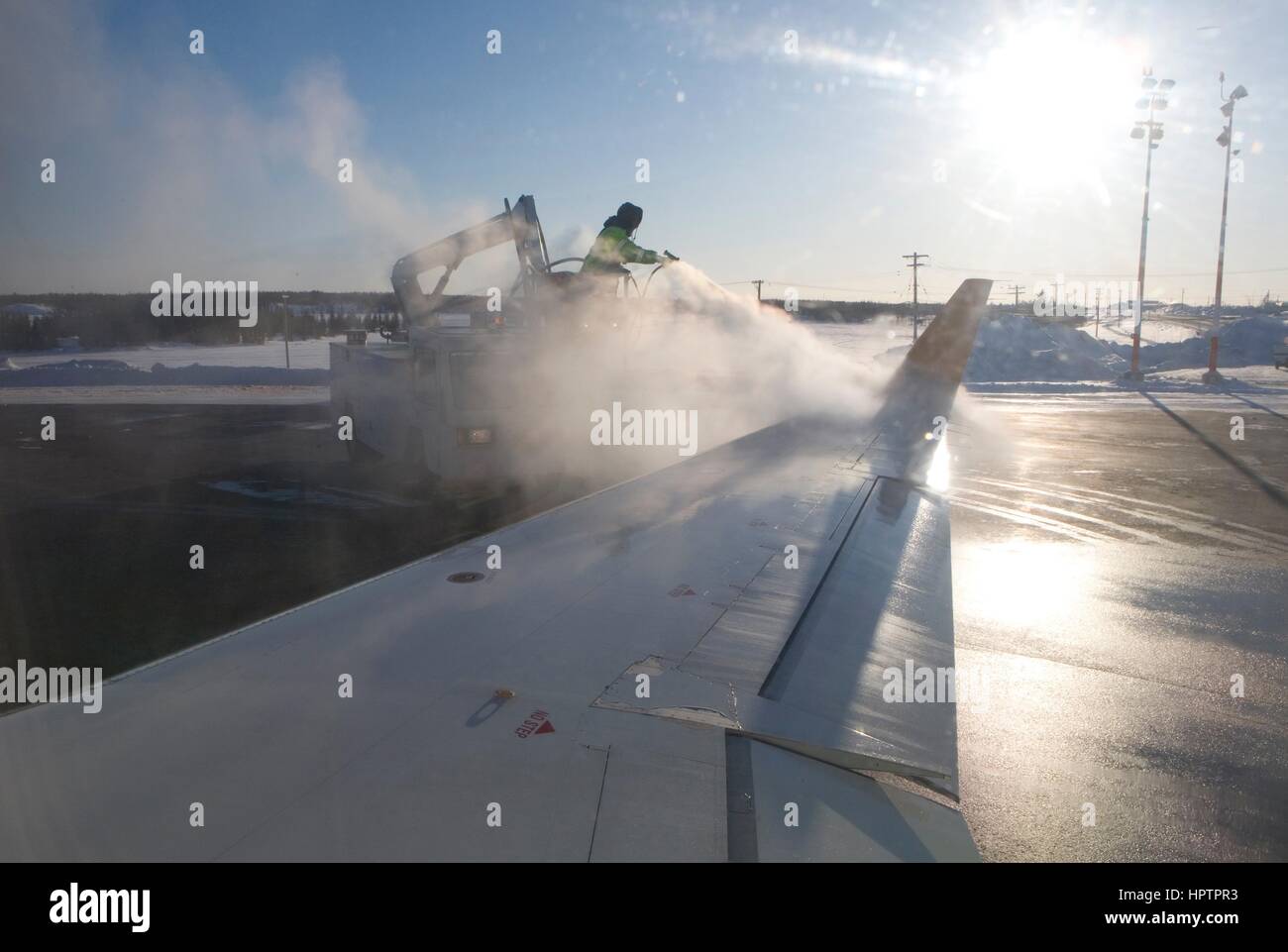 spraying ant frost liquid on a wing's plane before take off Stock Photo ...