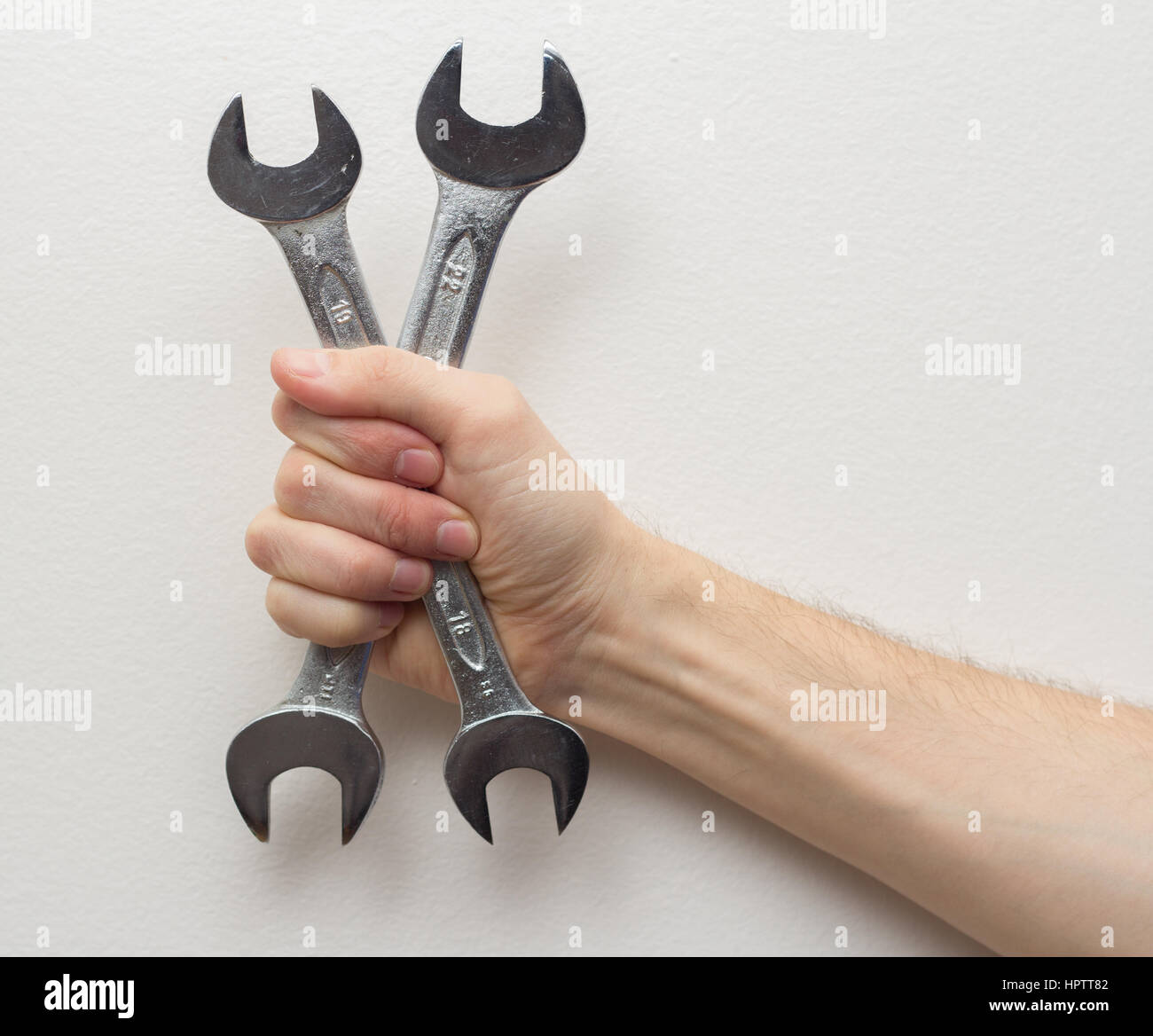 man hand holding wrenches Stock Photo - Alamy