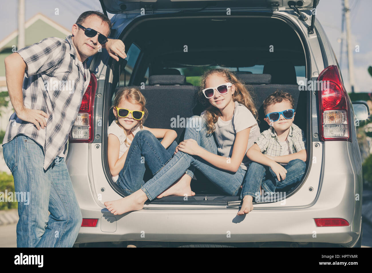 Happy family getting ready for road trip on a sunny day. Concept of ...