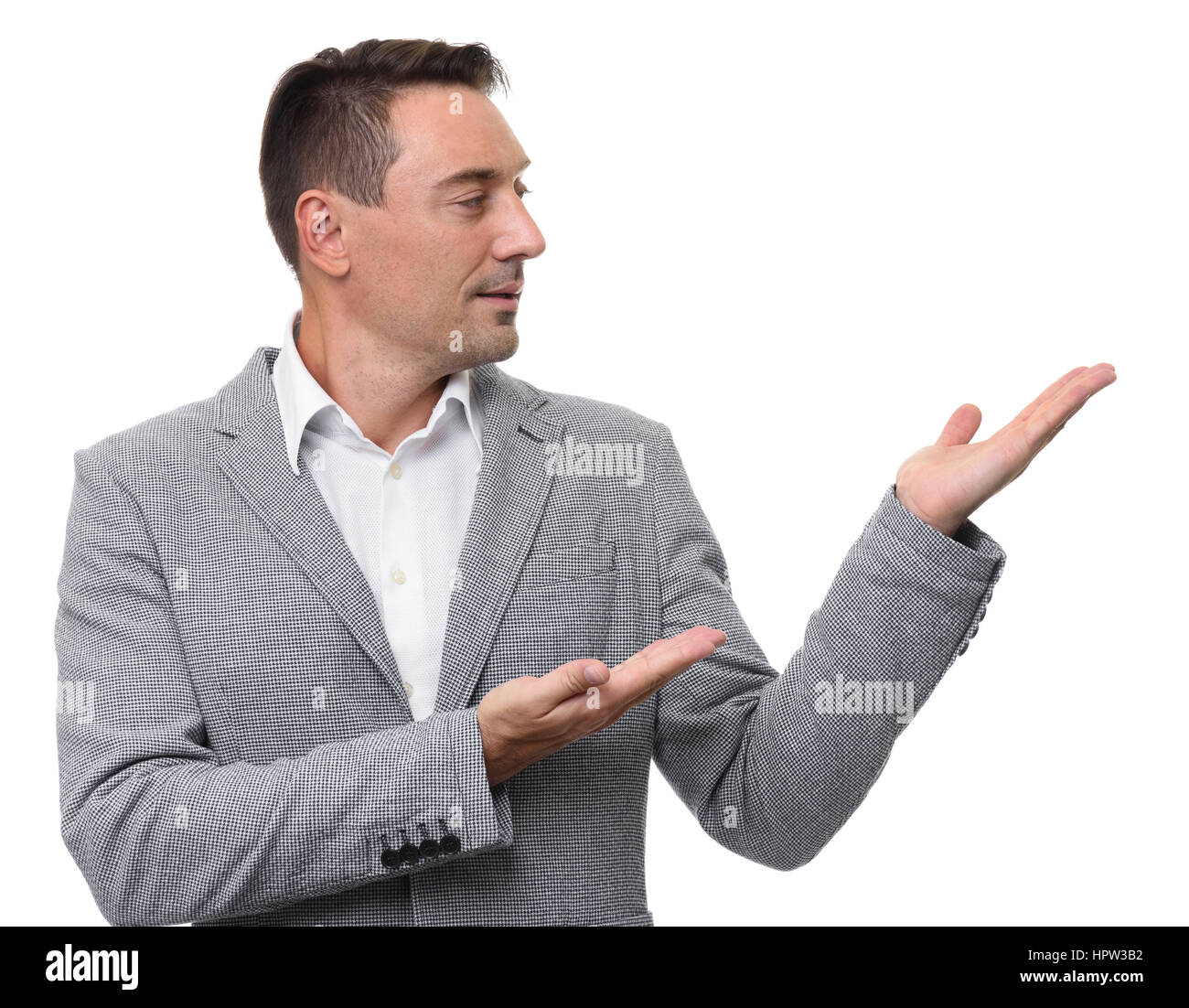 Handsome Businessman pointing copy space while standing against white ...