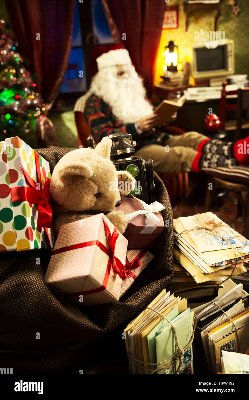 The messy desk of Santa Claus, he reading a book Stock Photo - Alamy