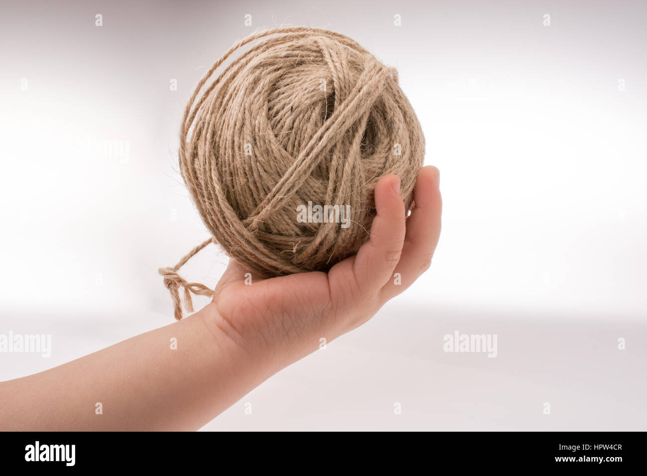 Spools of thread in hand isolated on a white background Stock Photo - Alamy