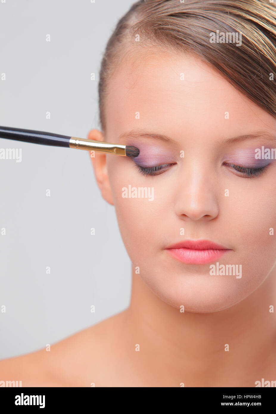 Portrait of beautiful fashion model applying professional makeup Stock ...