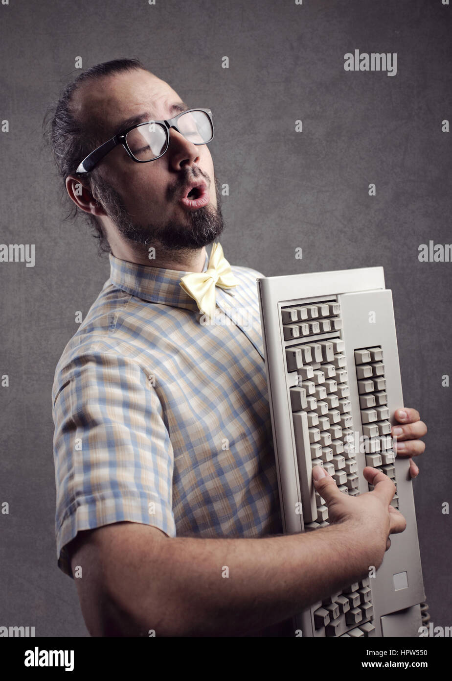 Funny man playing with a keyboard Stock Photo - Alamy